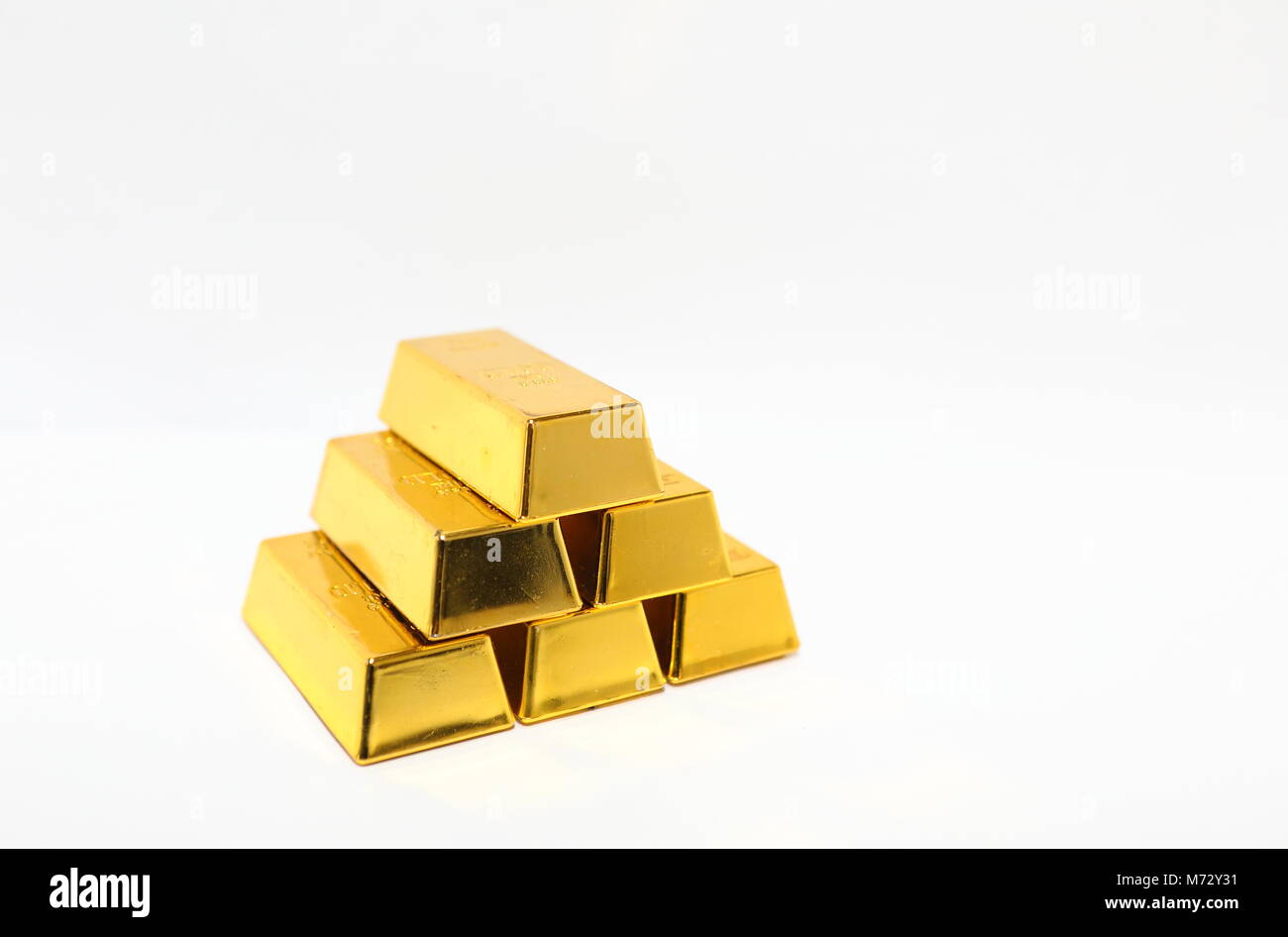 Gold bar pile isolated white background Stock Photo - Alamy