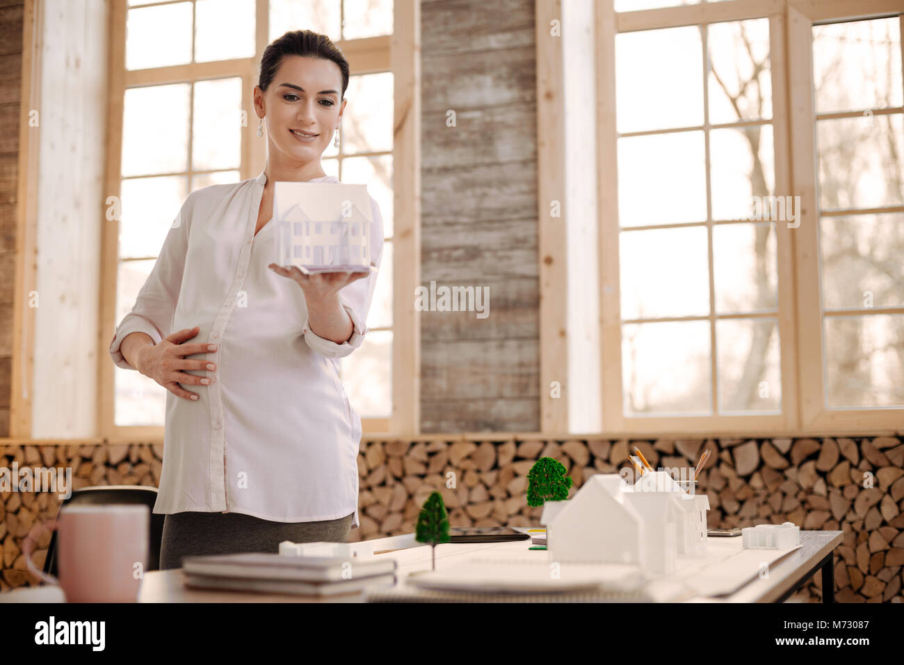 Skillful pregnant designer finishing model Stock Photo - Alamy