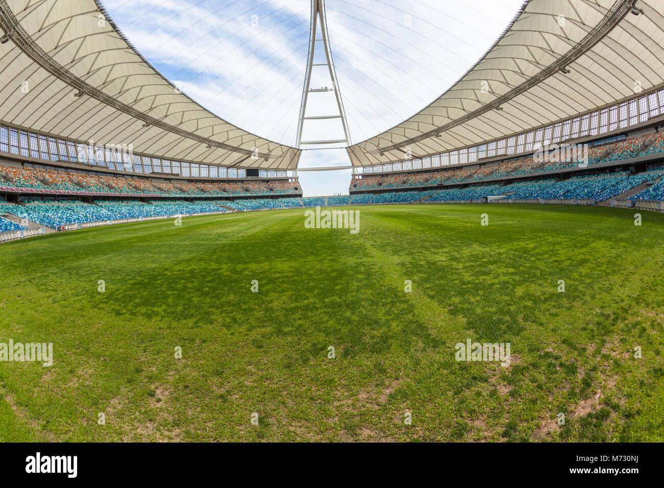 Football stadium grass field and surrounding spectator fan chairs full ...