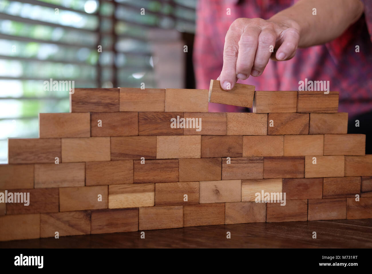 woman hand stacking wood block. growth, success & development in ...