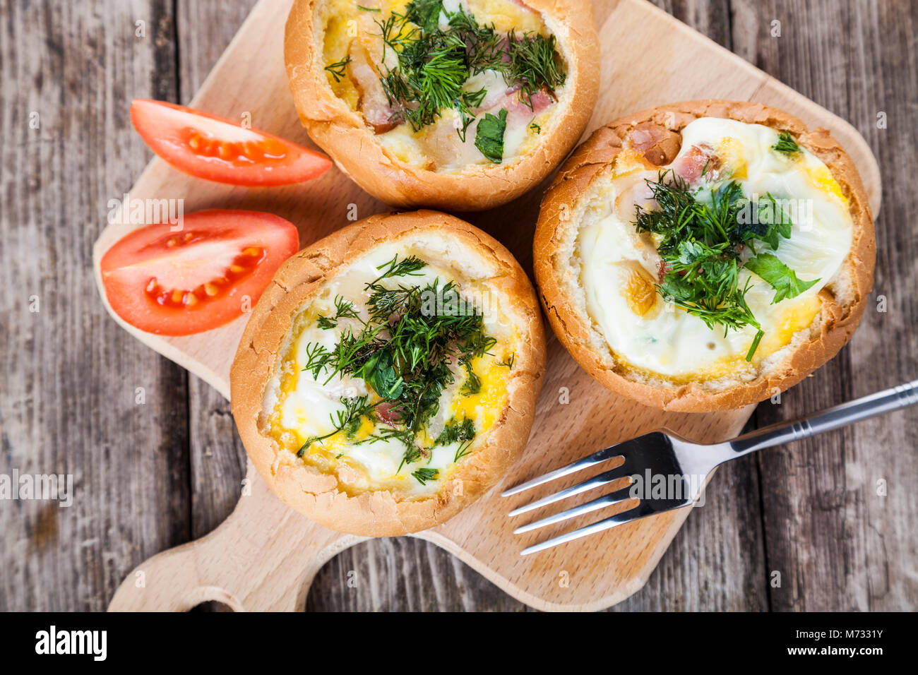 Scrambled eggs with cheese and bacon in a bun. Tasty breakfast Stock ...