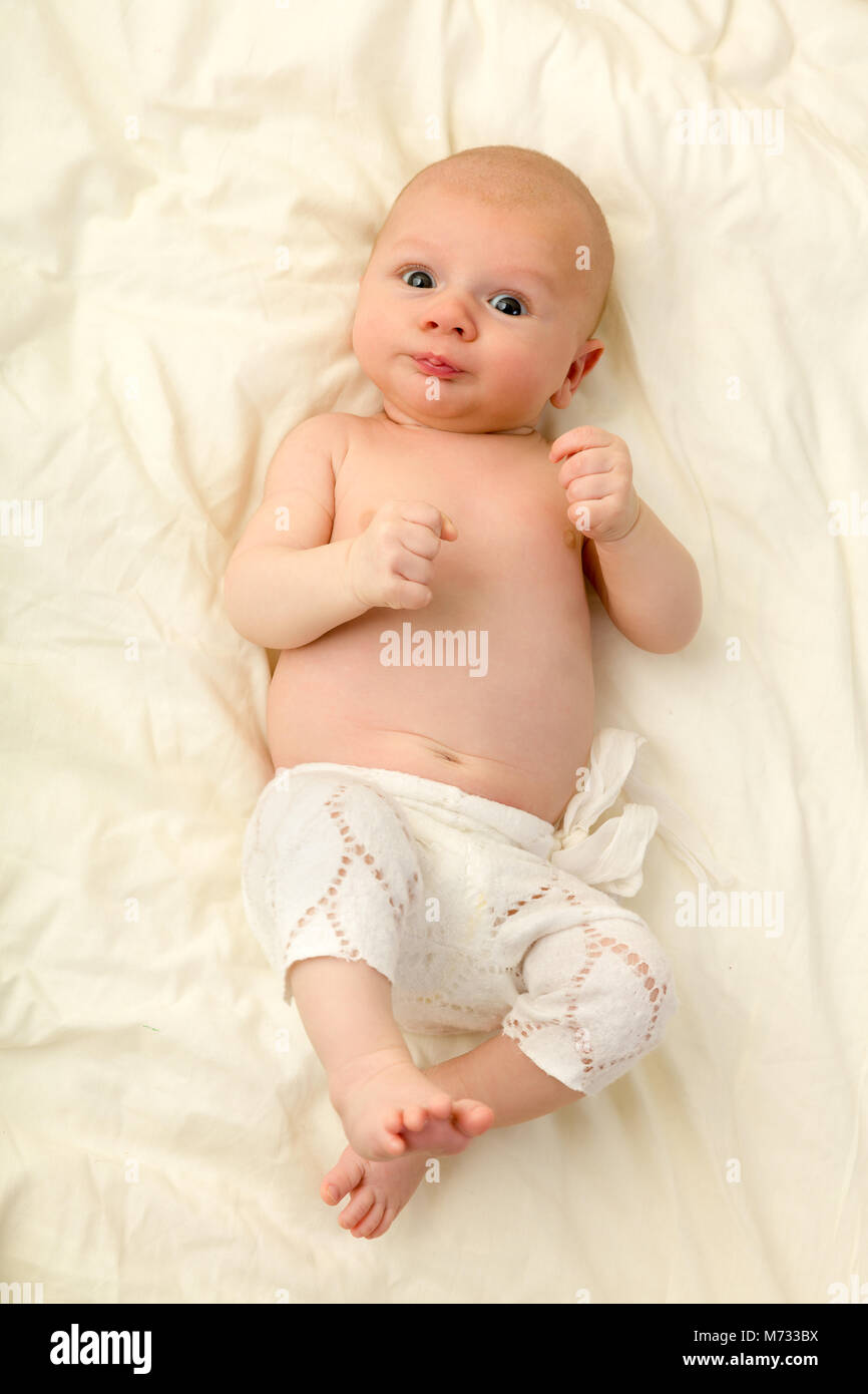 Happy little 7 week old baby with eyes wide open Stock Photo - Alamy