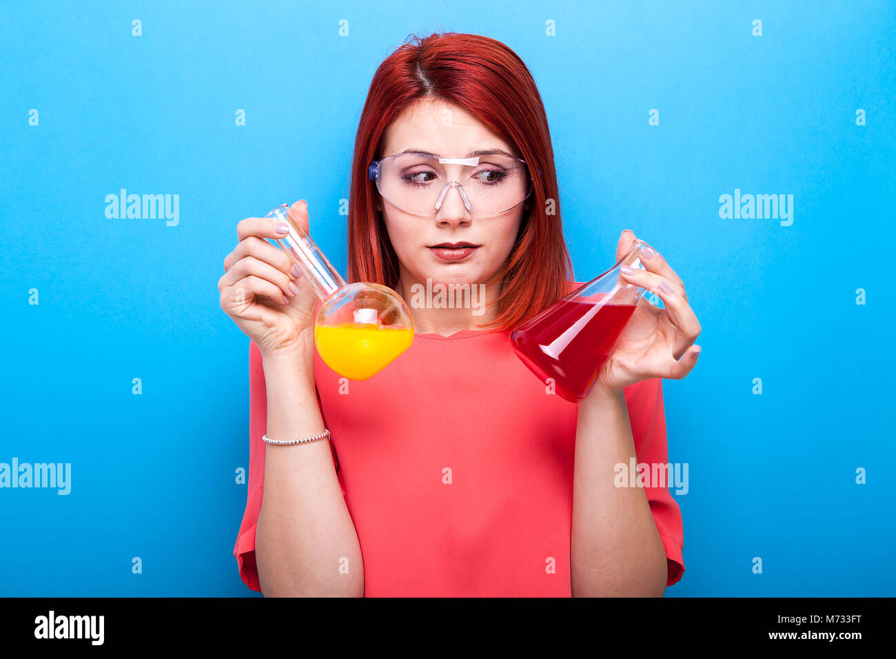 Nerd confused scientist woman wearing protective glasses and hol Stock ...