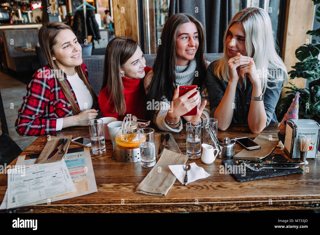 company friends talking in a cafe and having fun Stock Photo - Alamy