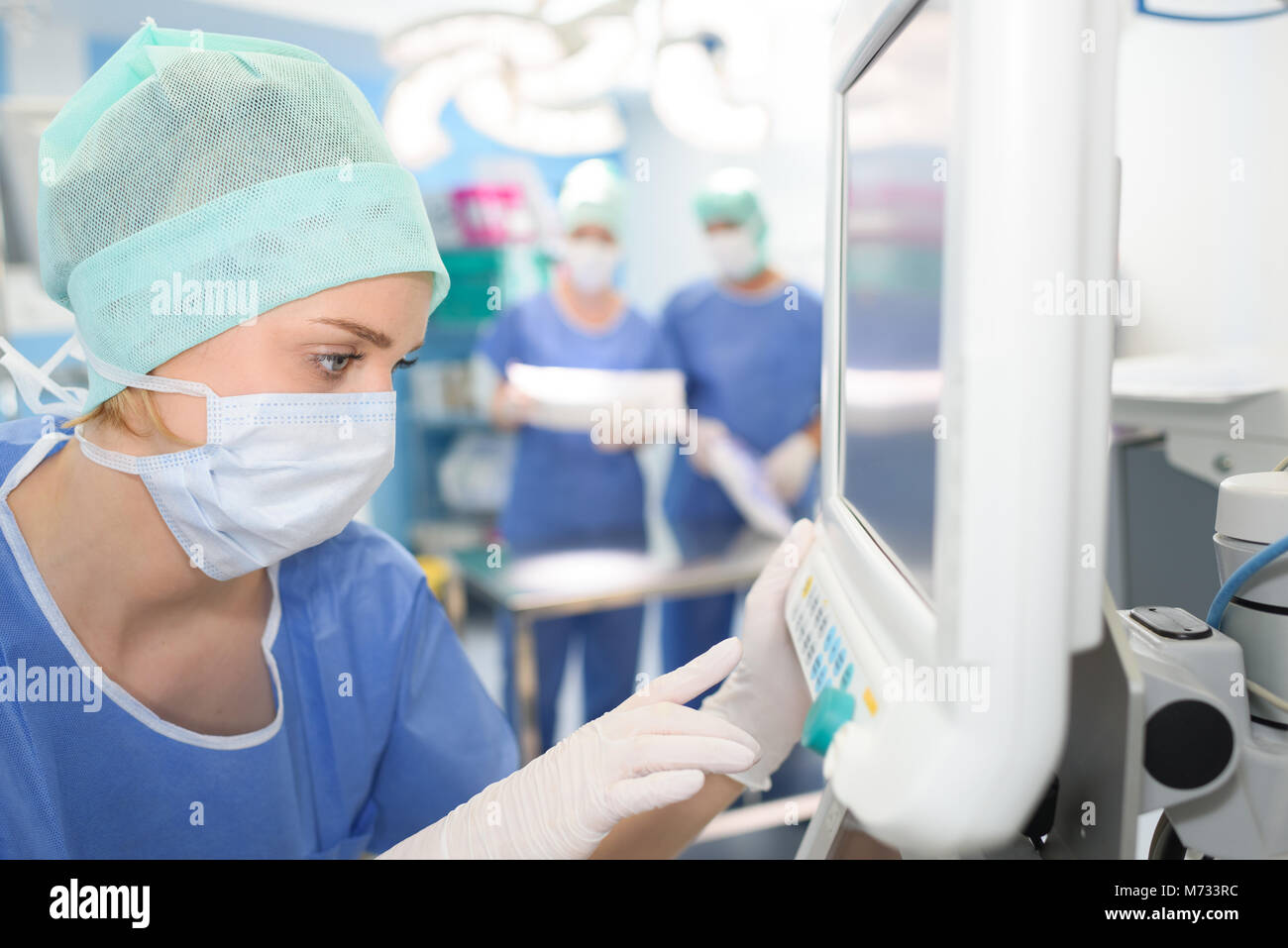 emale surgeon using digital tablet in operation room Stock Photo - Alamy