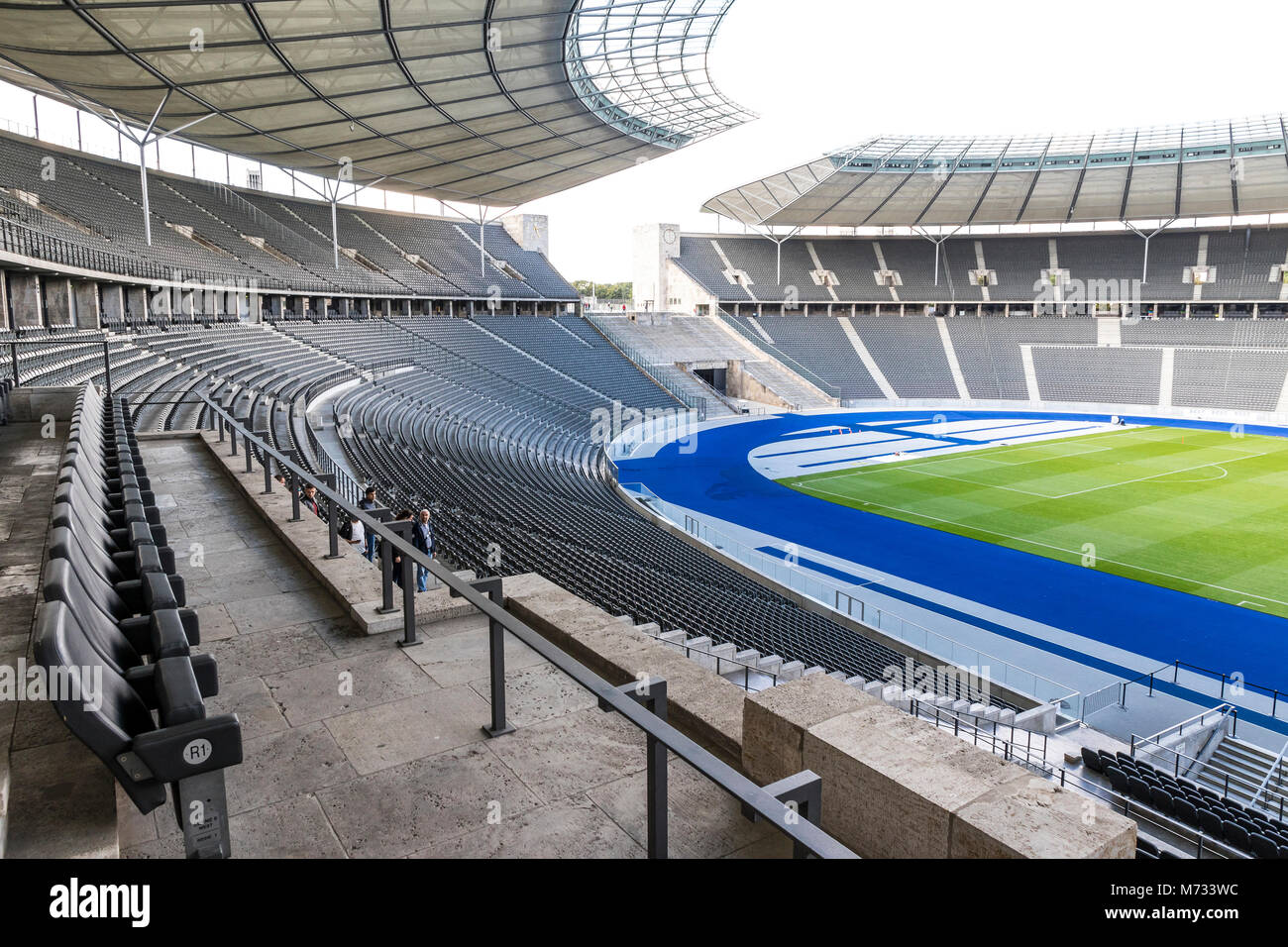 Green grass pitch and empty tribunes of Olympiastadion (Olympic Stadium ...