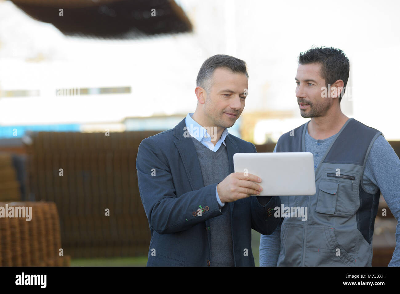 worker and manage using a tablet Stock Photo - Alamy