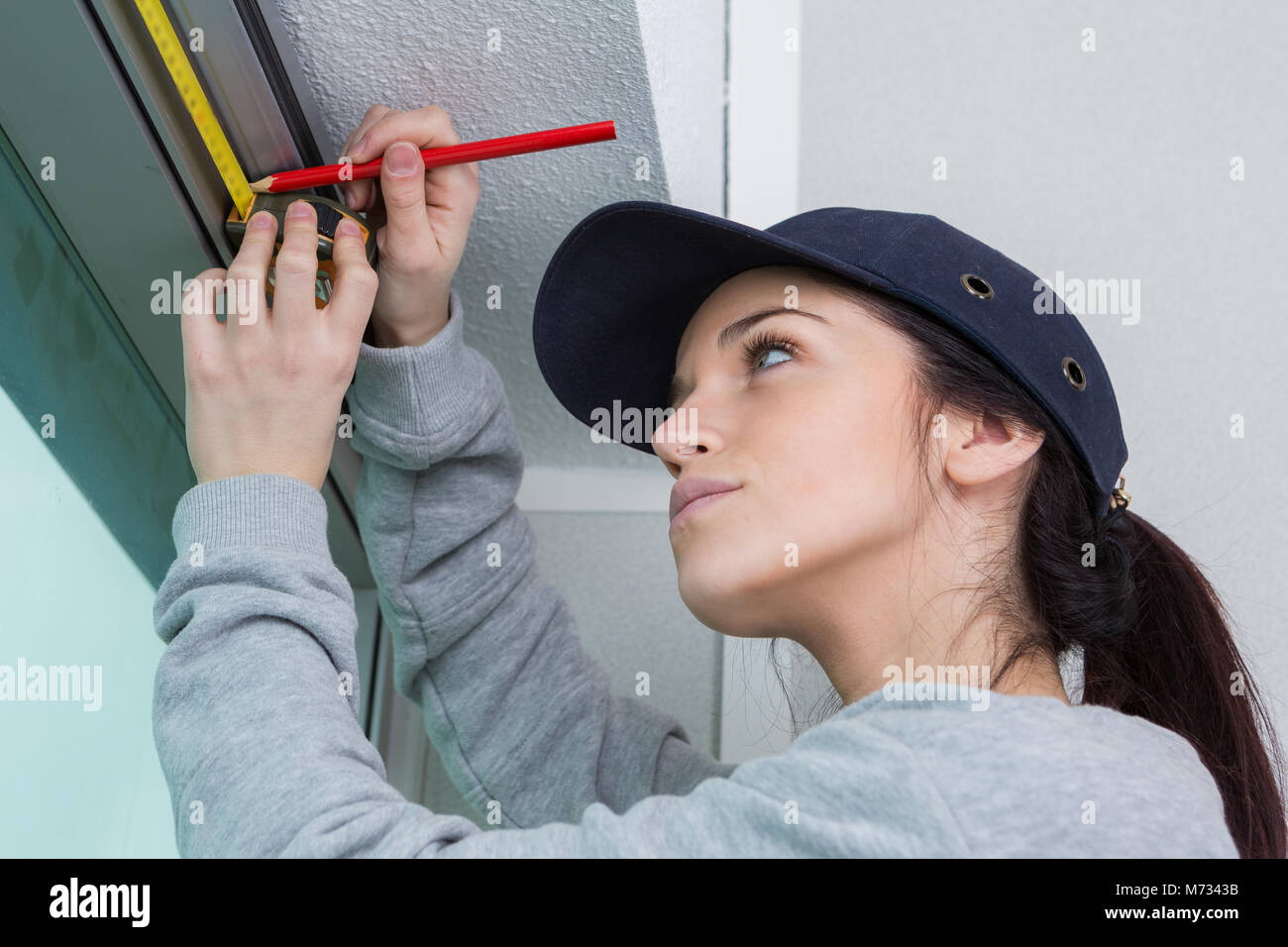 Woman marking point on window Stock Photo - Alamy