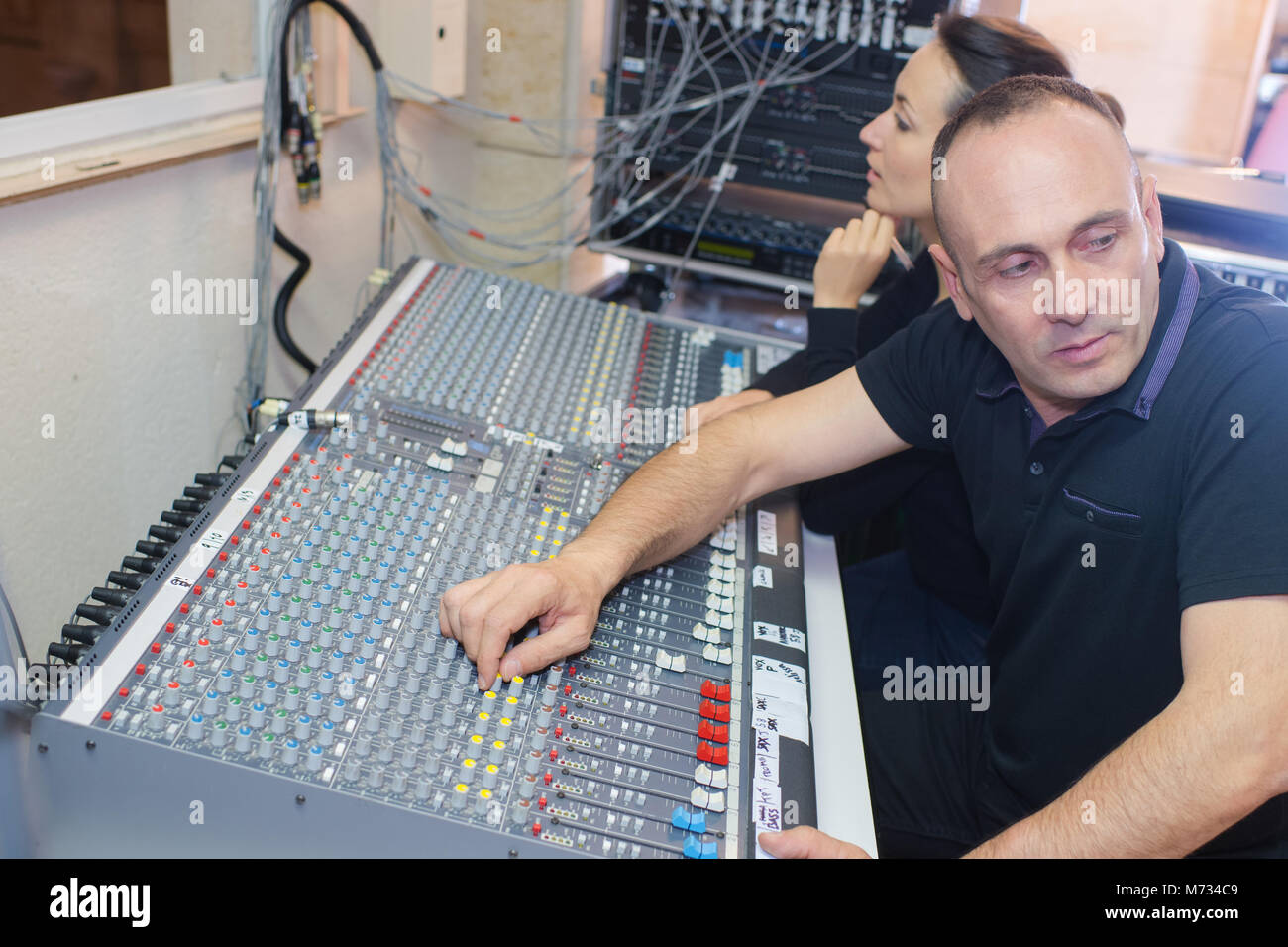 Man and woman in sound booth Stock Photo - Alamy