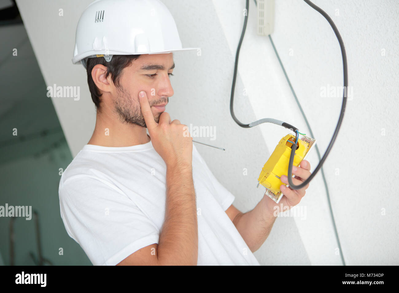 young man installing socket on wall at home Stock Photo - Alamy
