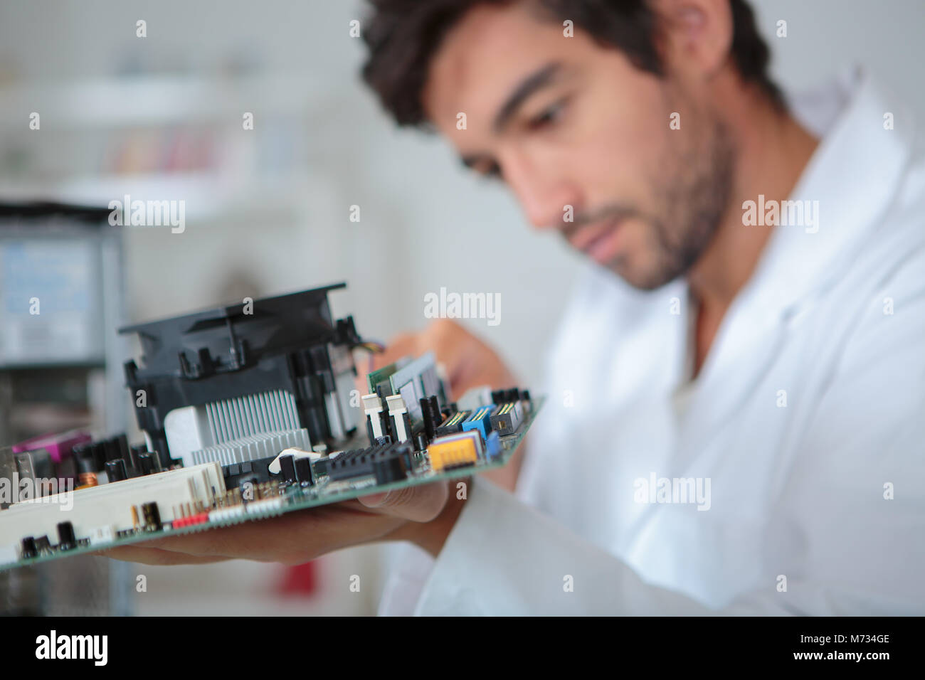 young engineer working on electronics components Stock Photo - Alamy