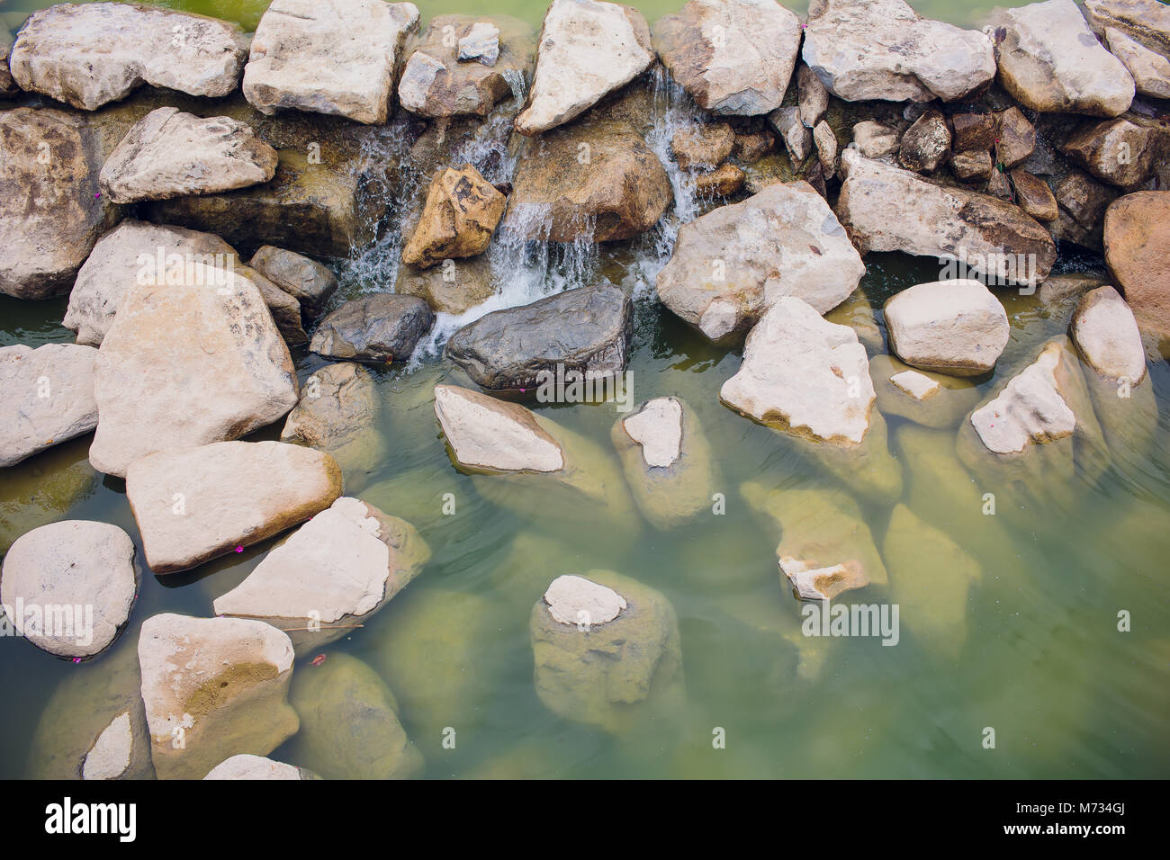Stone walkway on the pond park green Stock Photo - Alamy