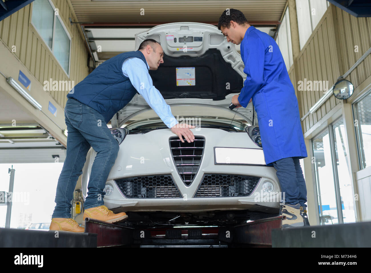 mechanics checking car engine Stock Photo - Alamy
