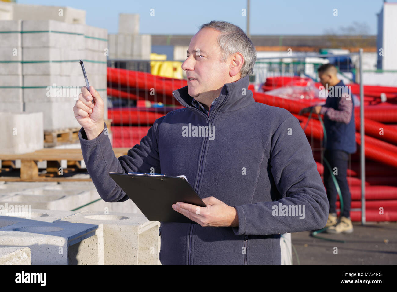 worker engineer pointing at construction Stock Photo - Alamy