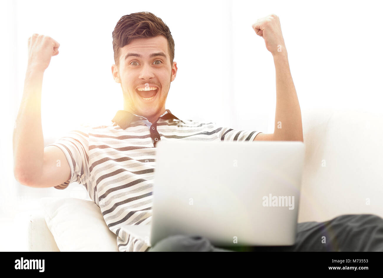 happy man with laptop sitting on the couch. photo with copy space Stock ...