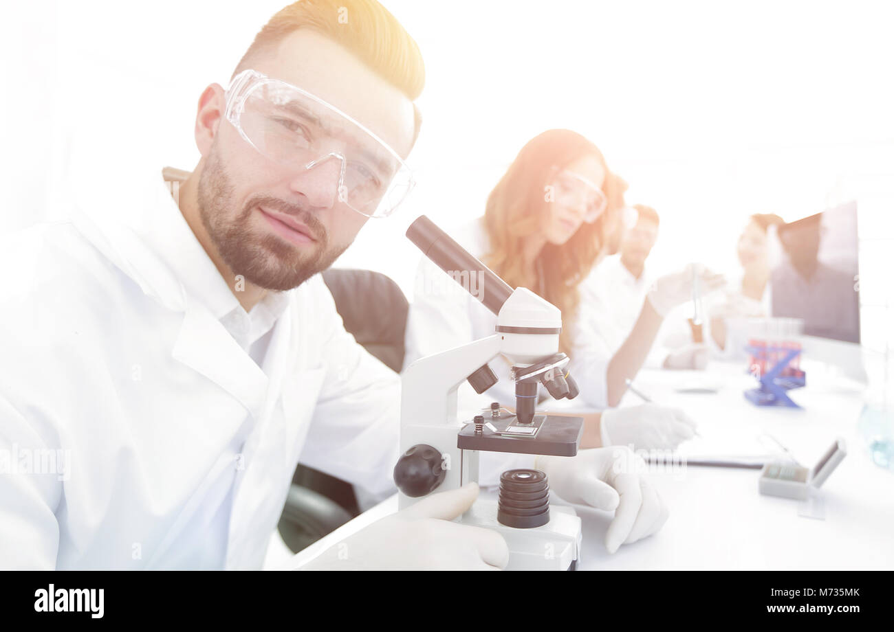 close-up of a scientific researcher with microscope in laboratory ...
