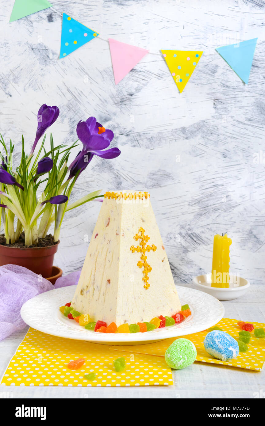 Traditional curd Easter cake with candied fruits and spring flowers ...