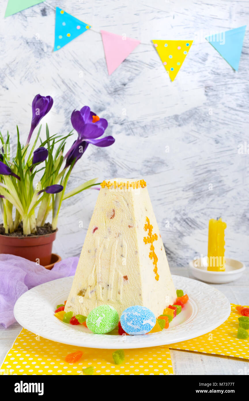 Traditional curd Easter cake with candied fruits and spring flowers ...