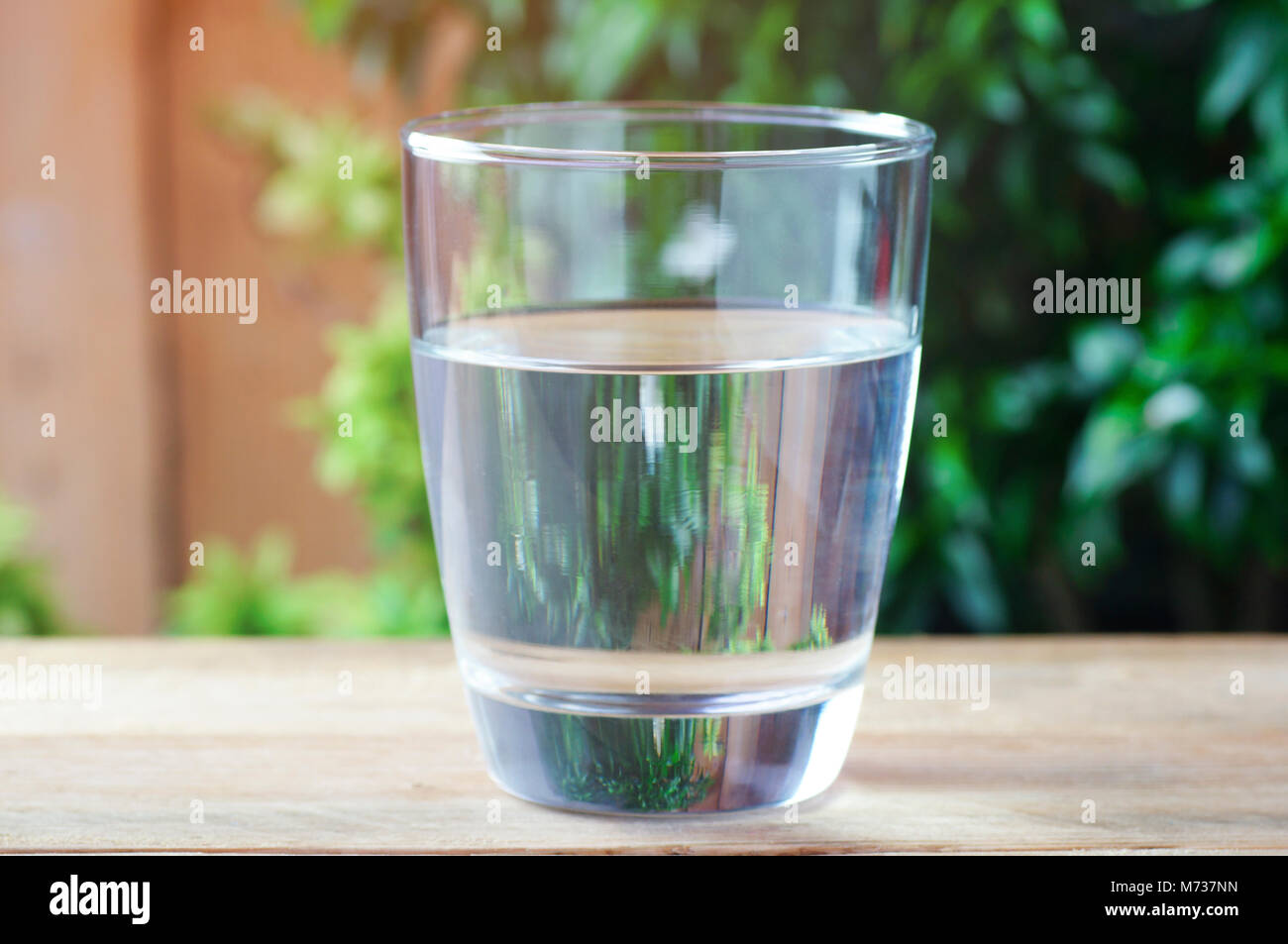drinking water on wood background Stock Photo - Alamy