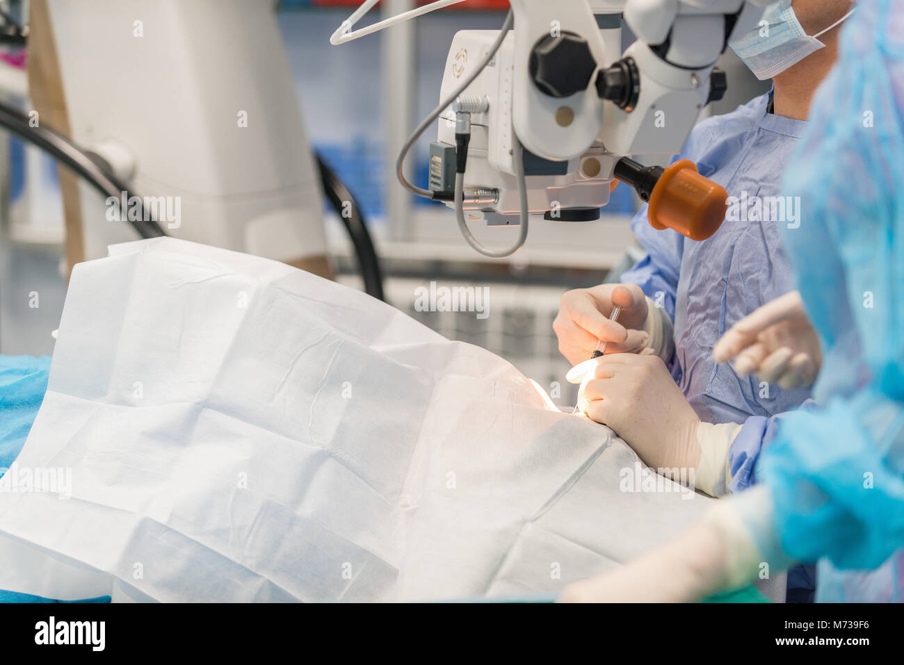 Doctors are in the process of conducting surgical operations on the eye ...