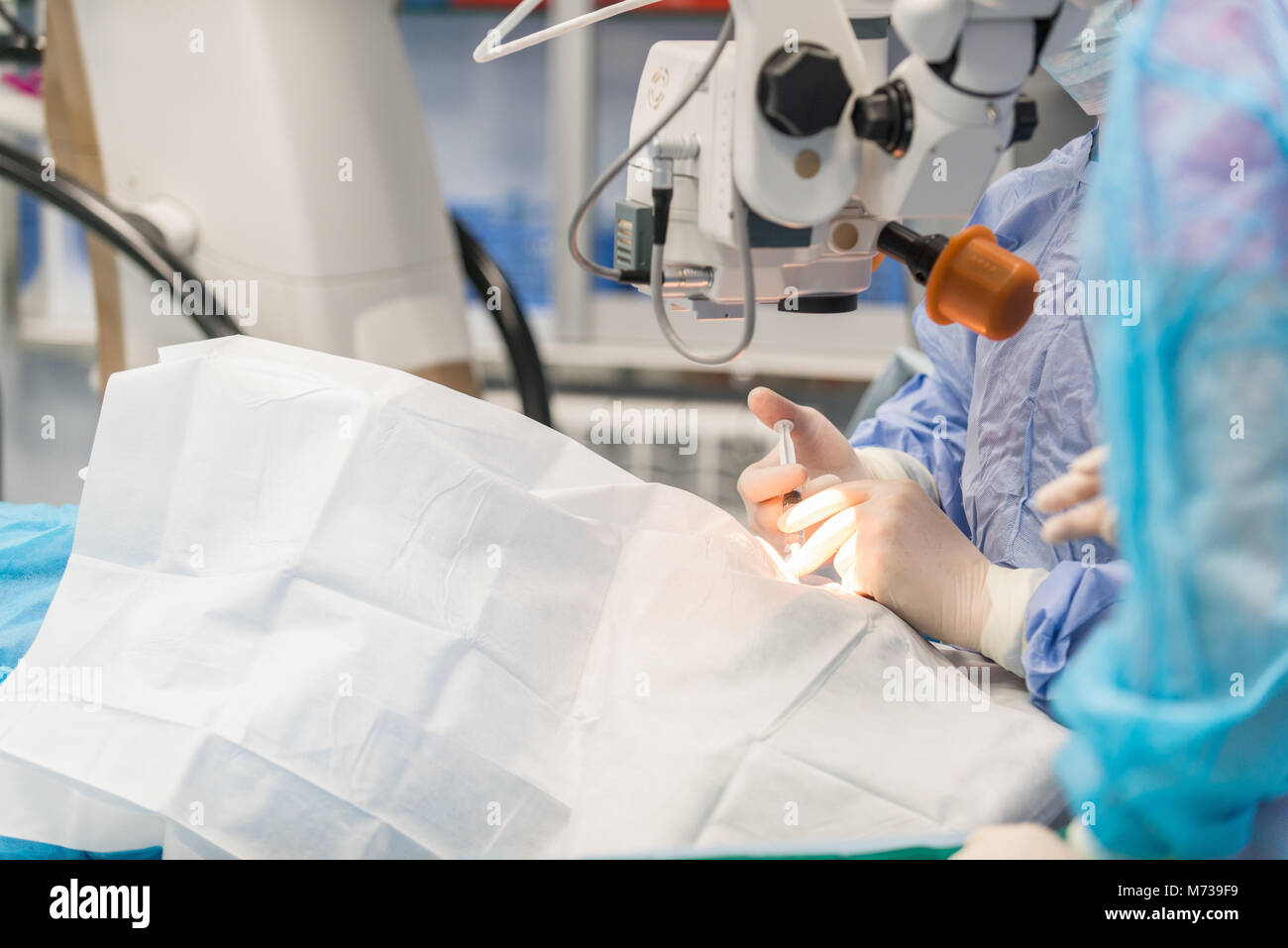 Doctors are in the process of conducting surgical operations on the eye ...