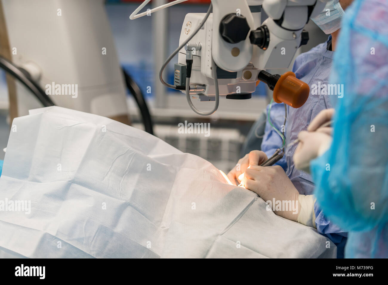 Doctors are in the process of conducting surgical operations on the eye ...