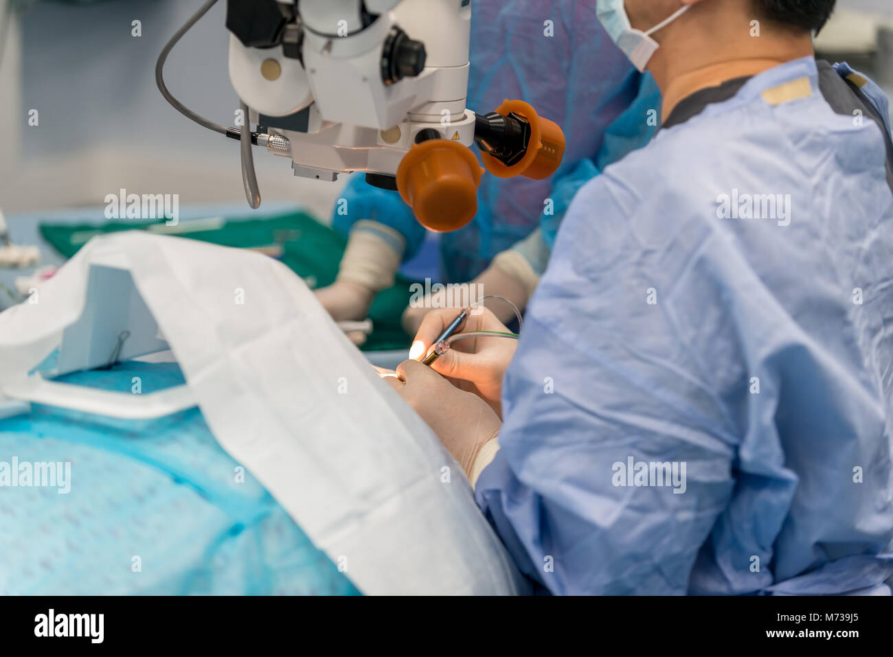 Doctors are in the process of conducting surgical operations on the eye ...