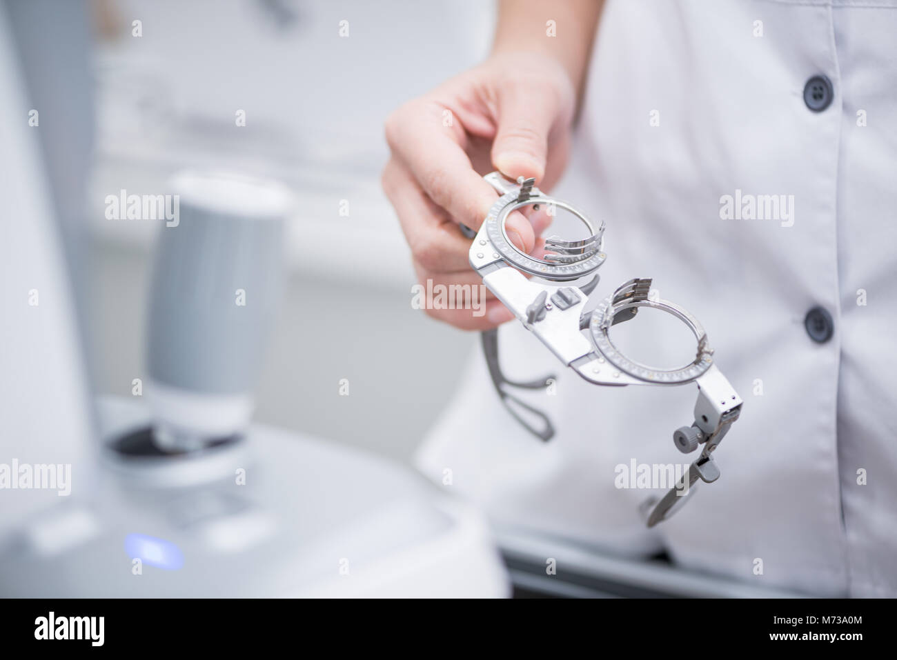 Woman doctor holds in his hands the optical test lenses for testing ...