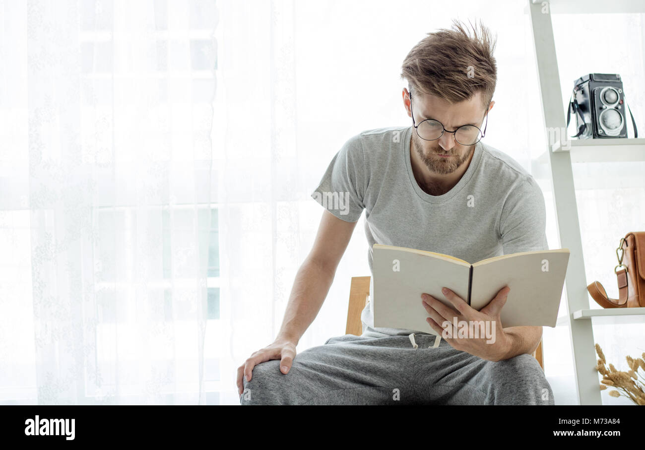 men read book in livingroom Stock Photo - Alamy