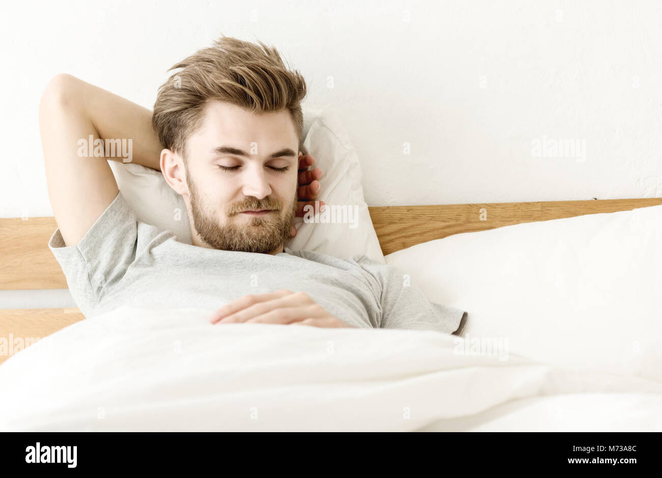 Men sleep on bed in the morning with in bed room Stock Photo - Alamy