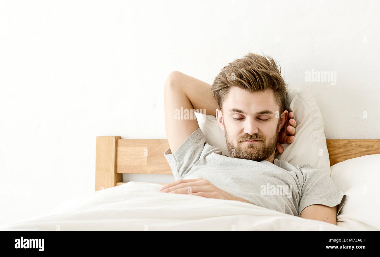 Men sleep on bed in the morning with in bed room Stock Photo - Alamy