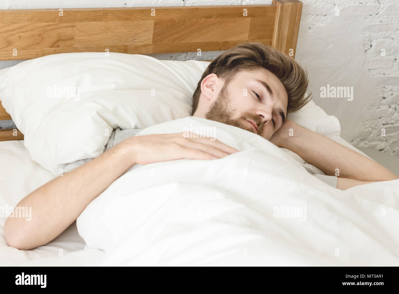 Men sleep on bed in the morning with in bedroom Stock Photo - Alamy