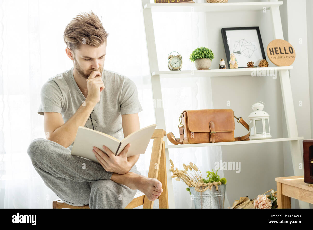 men read book in living room with in morning Stock Photo - Alamy