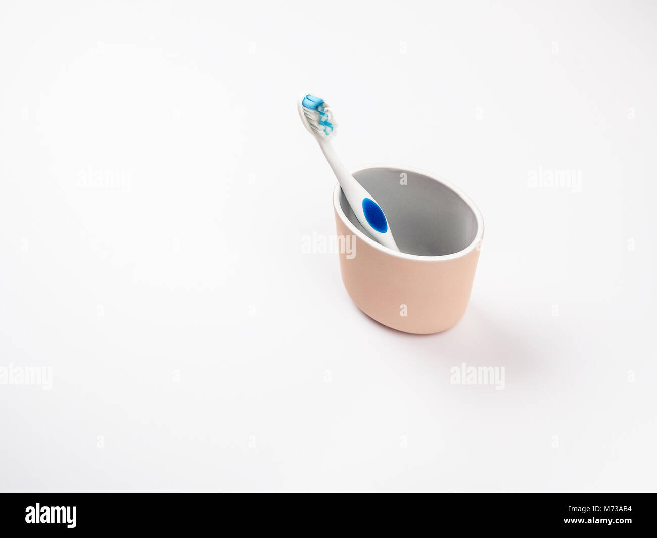 Used and old toothbrush in cup on white background Stock Photo - Alamy