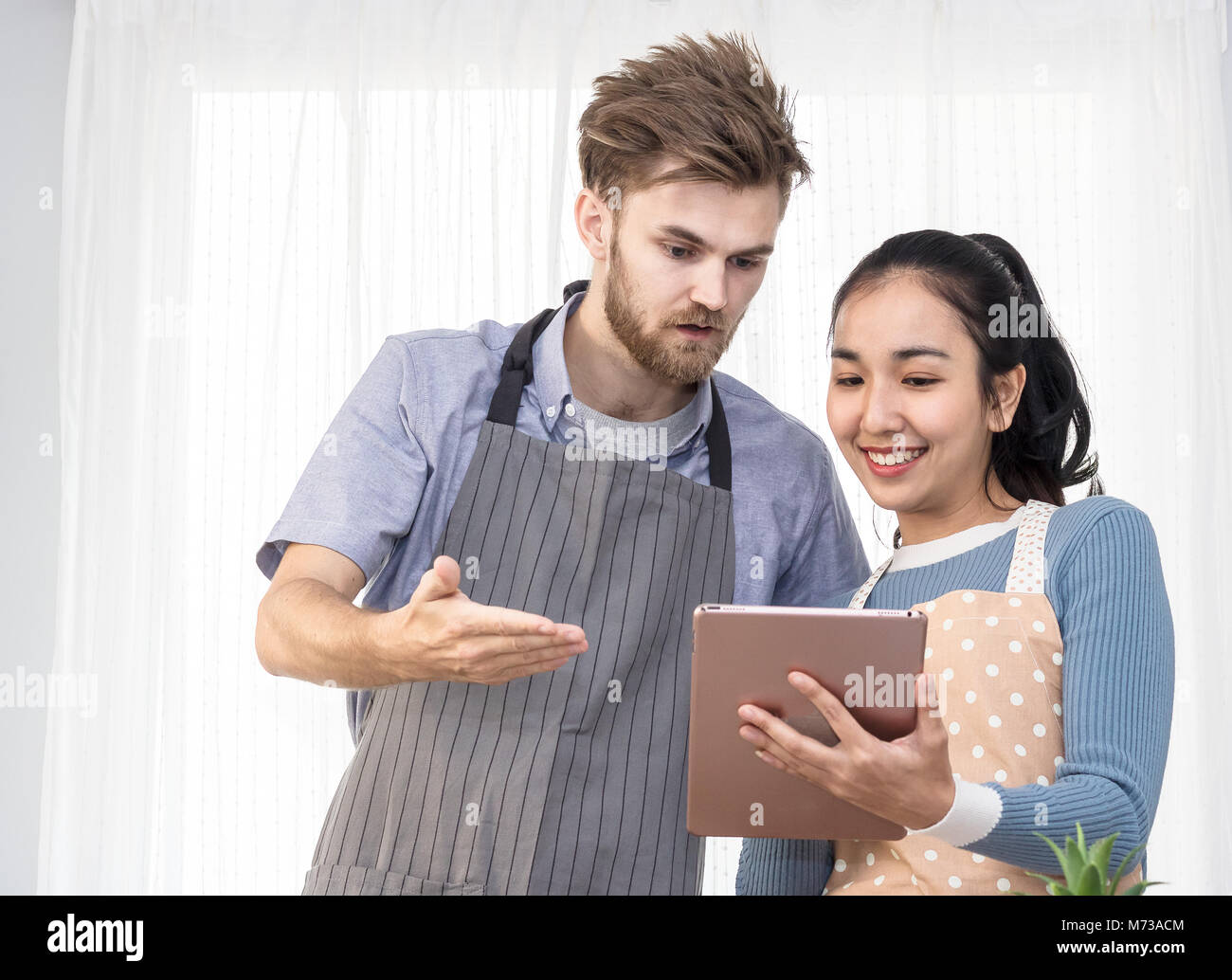 man and woman chef use tablet in kitchen room Stock Photo - Alamy