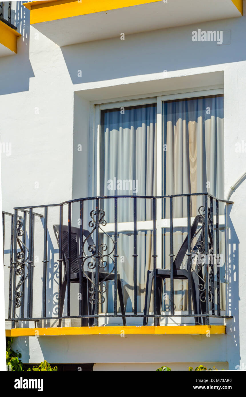 Stylish balcony with a metal railing, solid architectural element, a ...