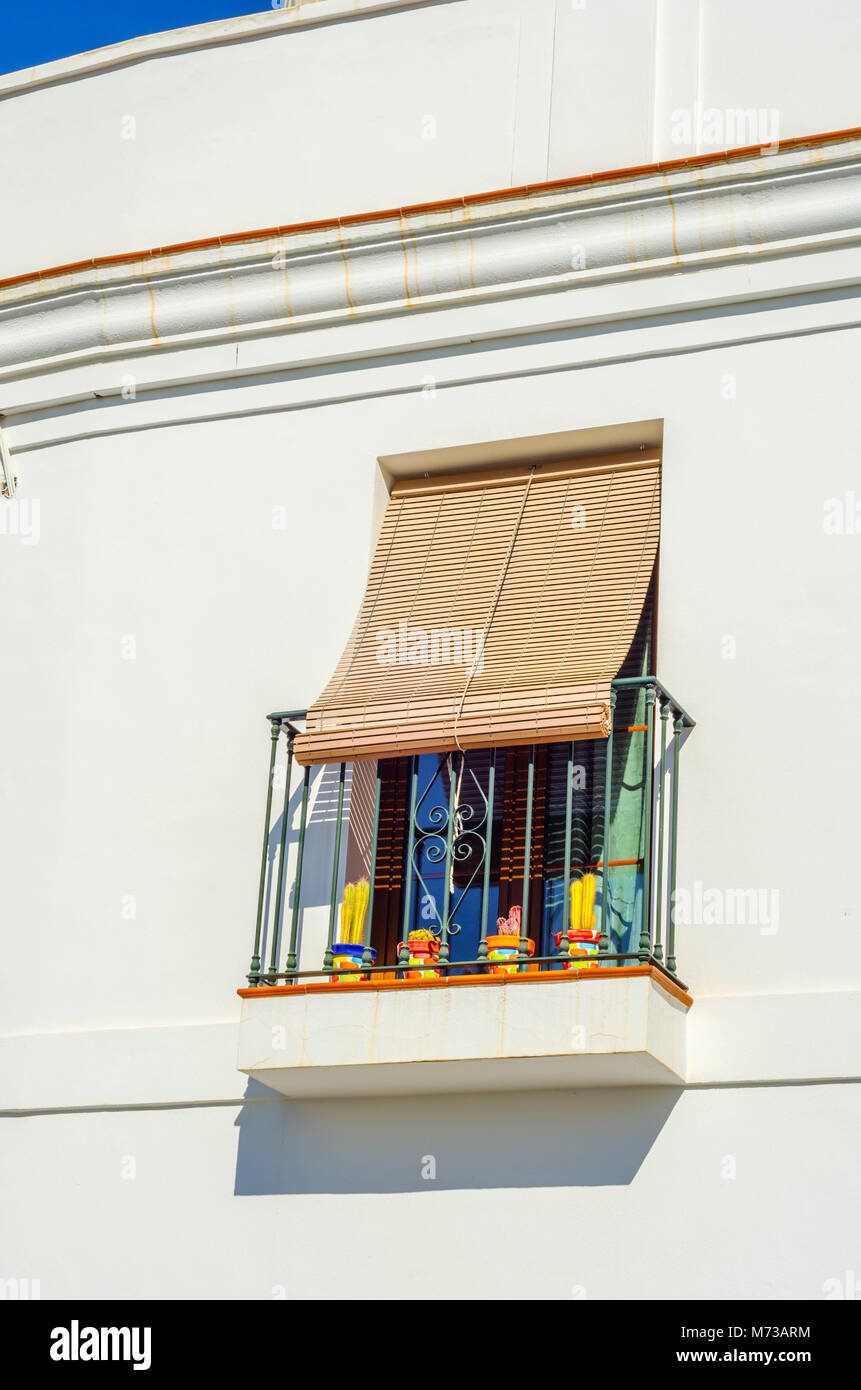 Stylish balcony with a metal railing, solid architectural element, a ...
