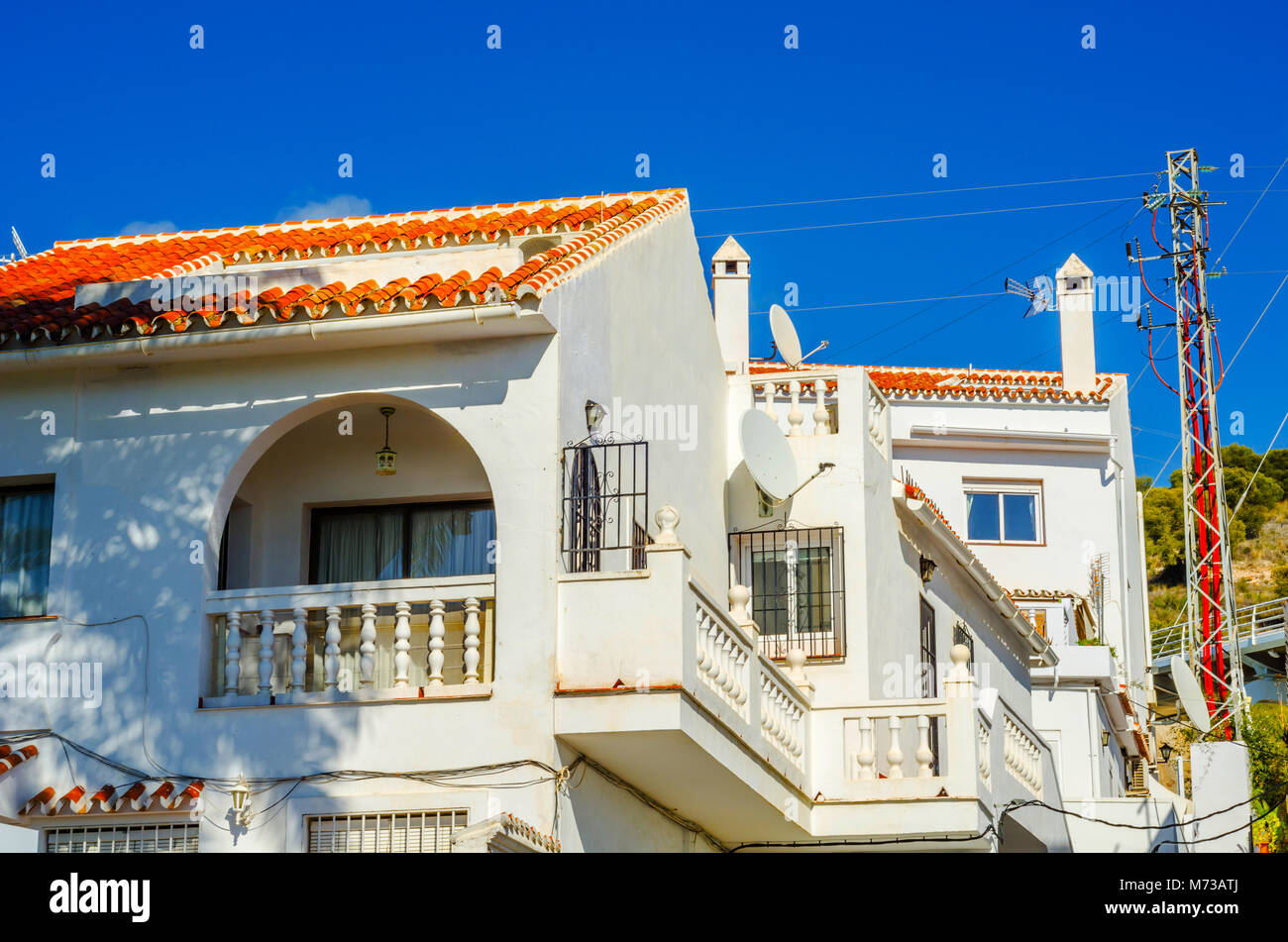 Stylish balcony with a metal railing, solid architectural element, a ...