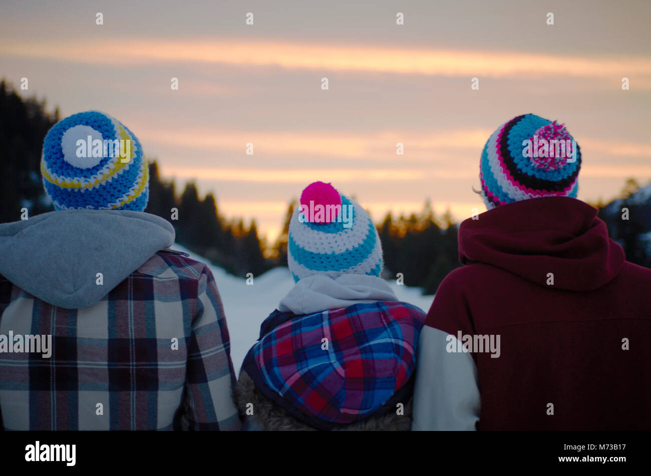 three people looking at sunset lifestyle holiday moments team holiday ...