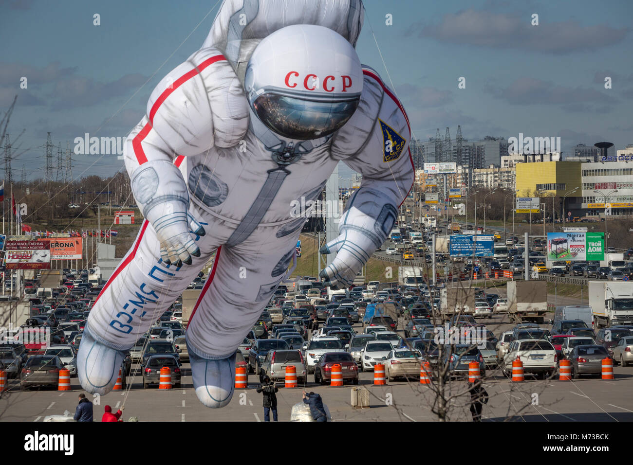 A balloon in the form of a Soviet cosmonaut flies over in Moscow city ...