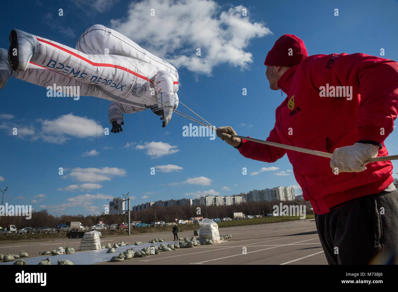A balloon in the form of a Soviet cosmonaut flies over in Moscow city ...