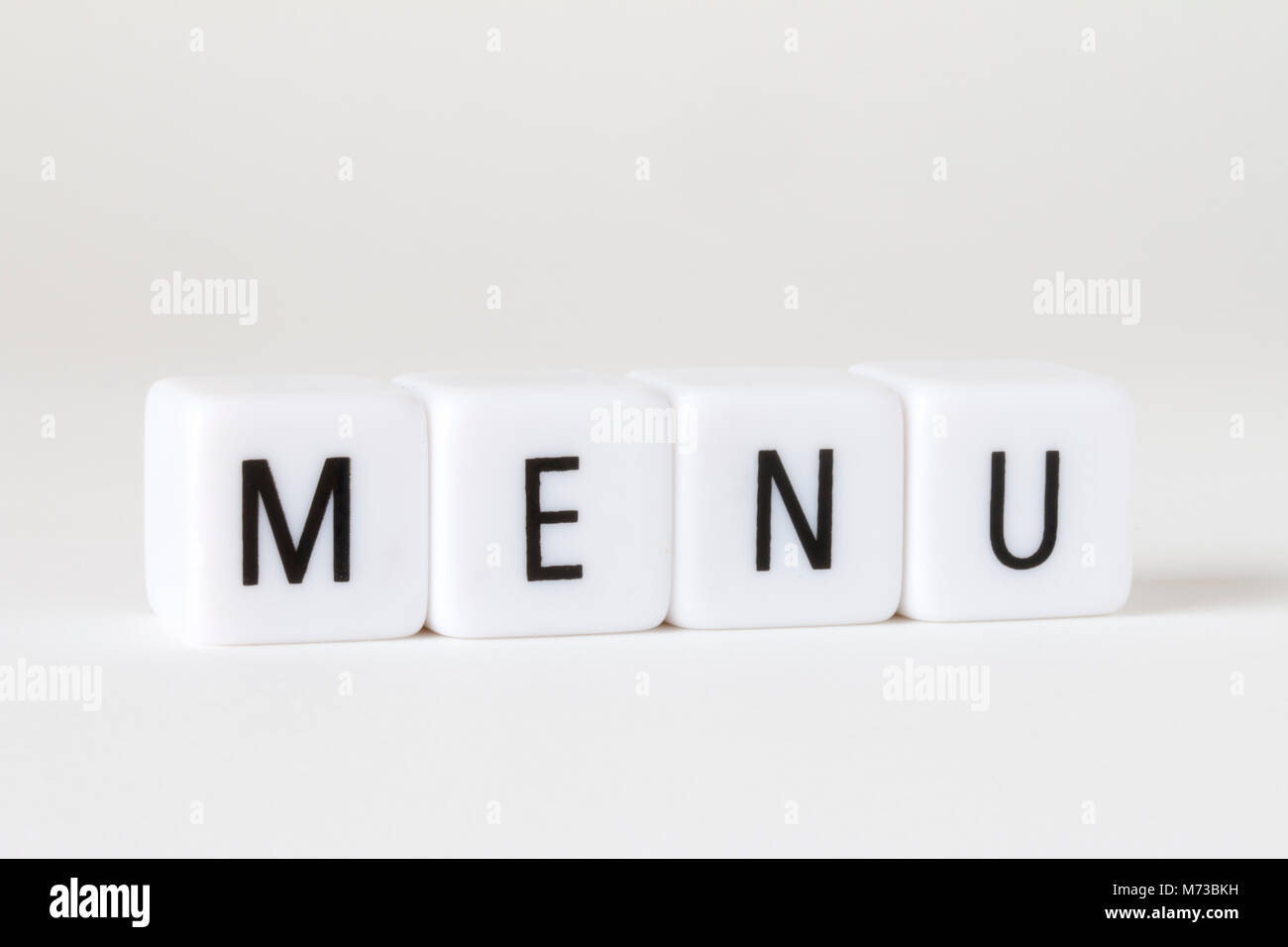 The character MENU written in the white cube Stock Photo - Alamy