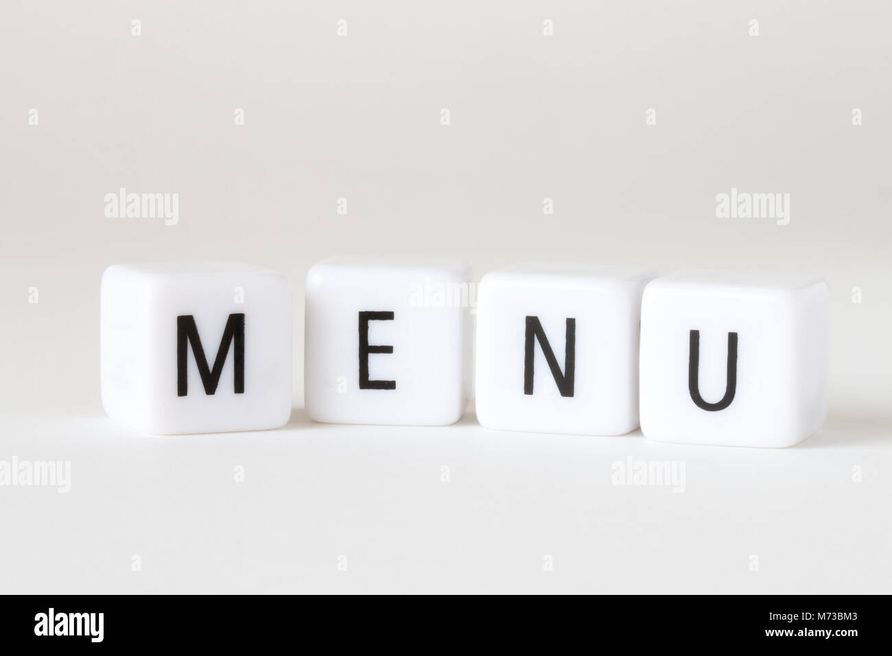 The character MENU written in the white cube Stock Photo - Alamy