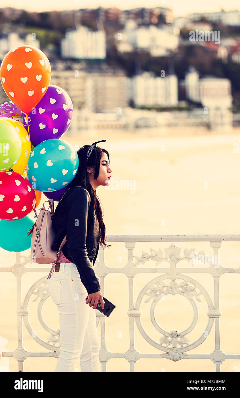 San Sebastian, Spain-March 07,2018: Young girl with colorful balloons ...