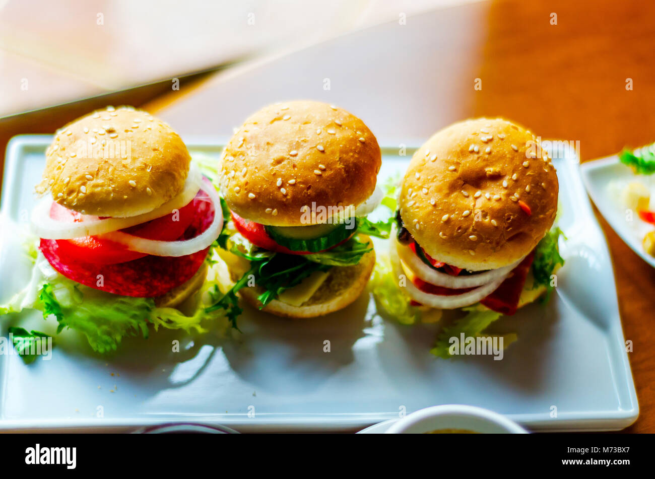 mini burgers with meat, vegetables, cheese and other toppings, bread ...