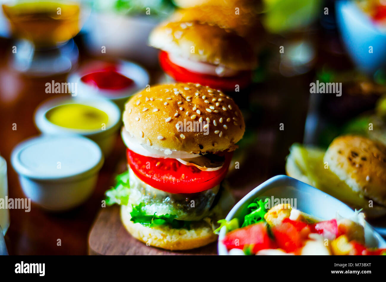 mini burgers with meat, vegetables, cheese and other toppings, bread ...