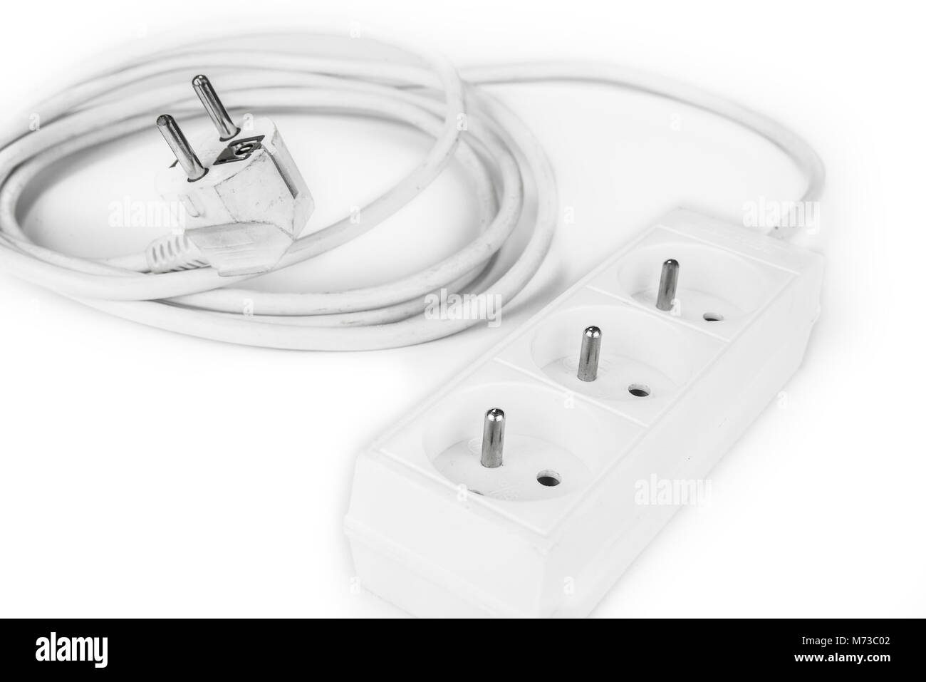 White extension cable with three plug socket on white Stock Photo - Alamy