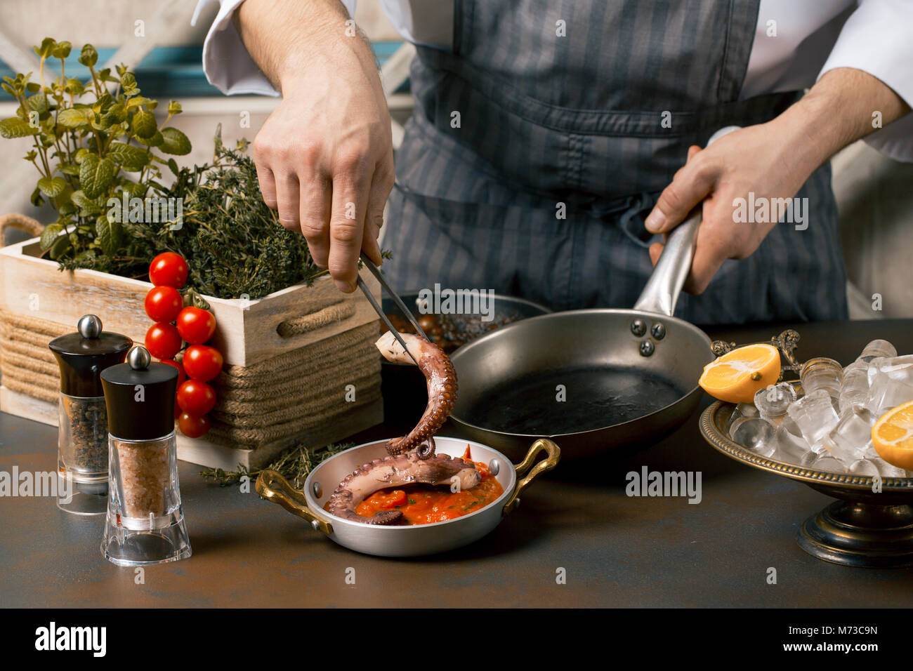 Chef cooks spreadsheets octopus tentacles. Chef lays octopus from the ...