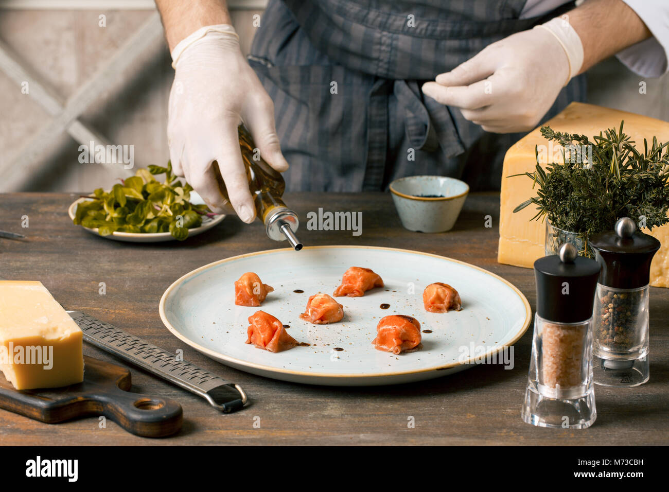 Chef preparing food in the restaurant kitchen. the boss is watering ...