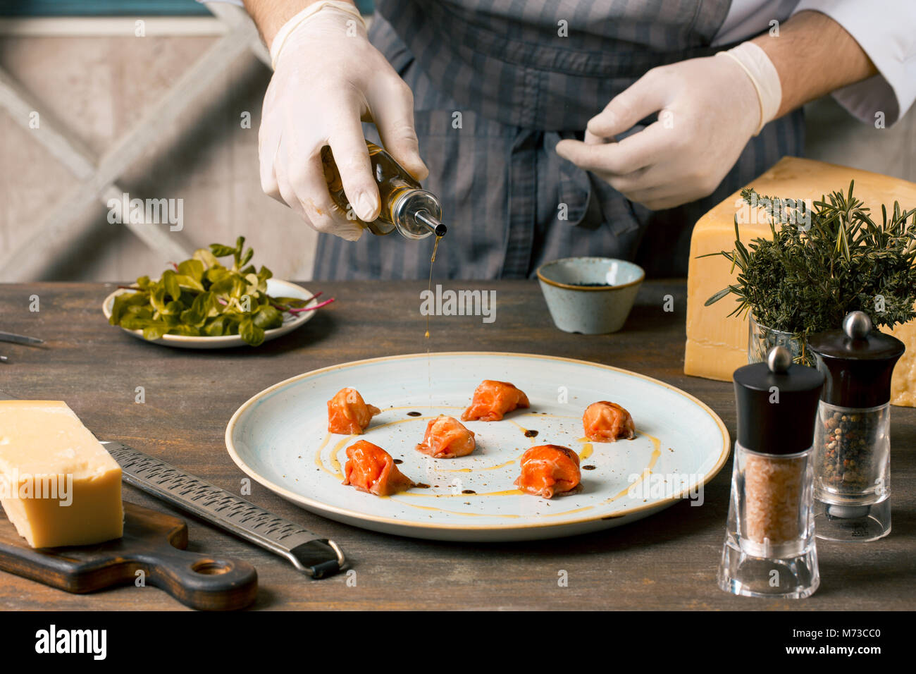 Chef preparing food in the restaurant kitchen. the boss is watering ...